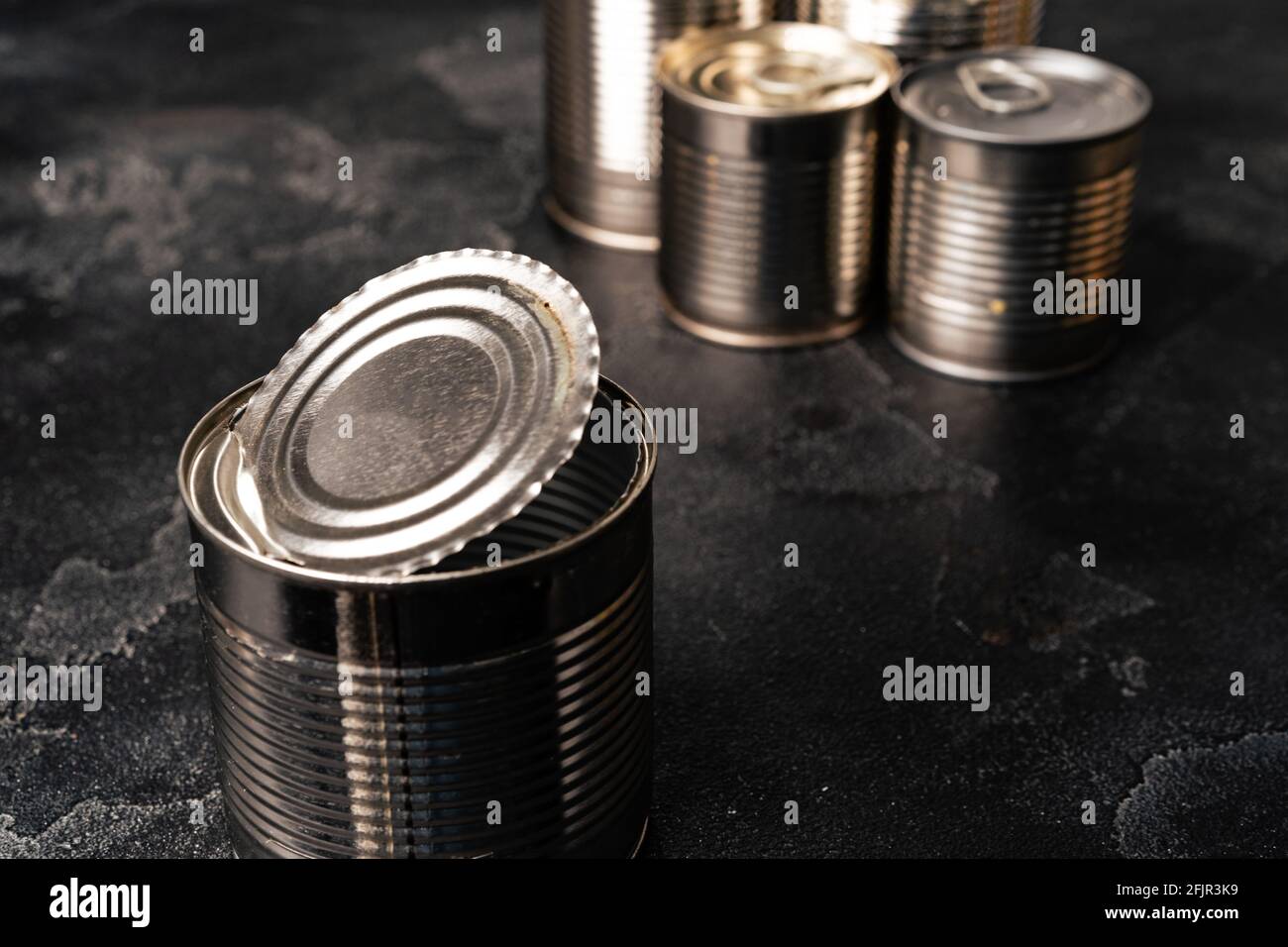 Tin cans with conserved food on gray surface Stock Photo - Alamy