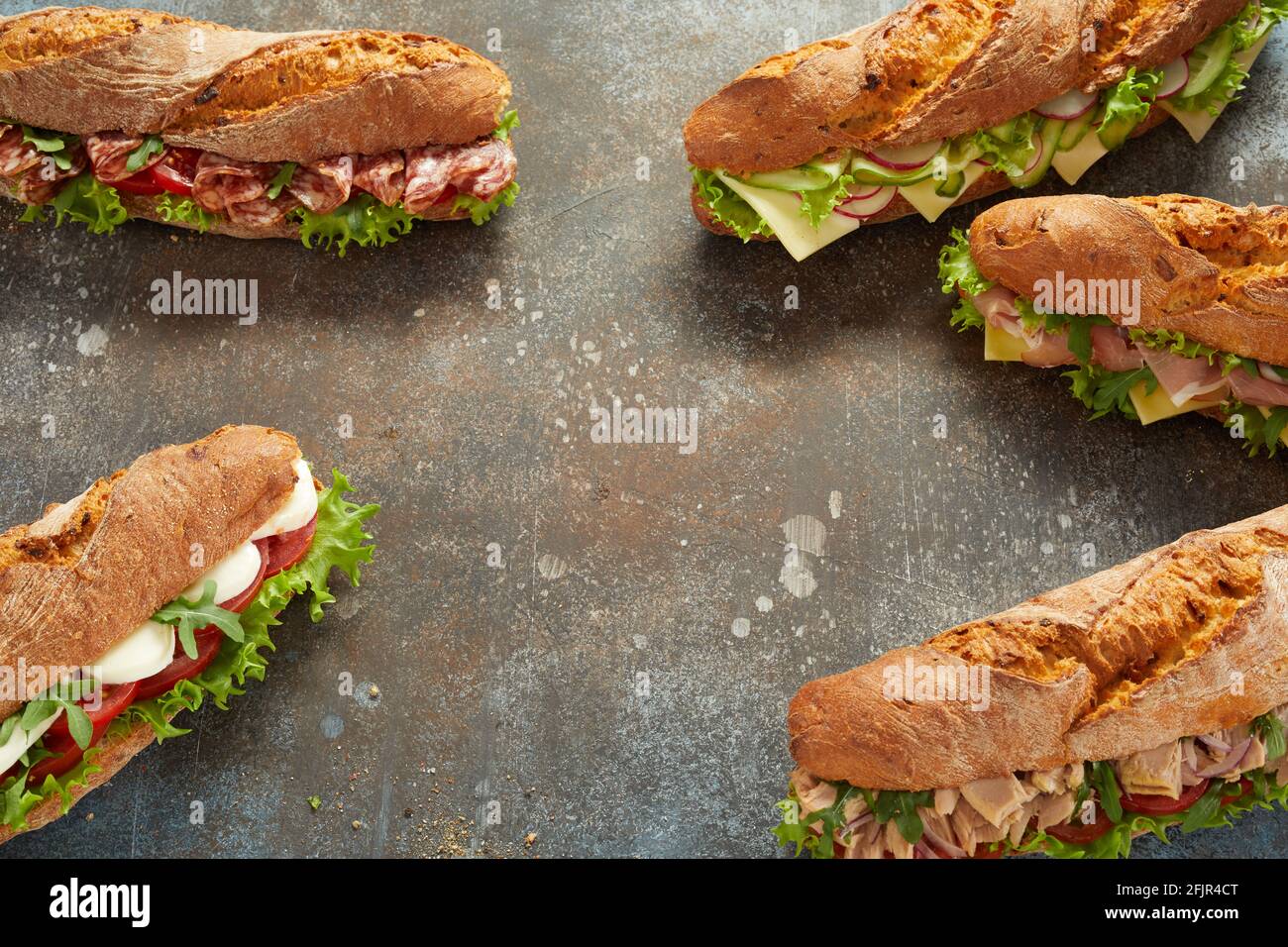 From above composition of yummy fresh sandwiches placed on shabby gray ...