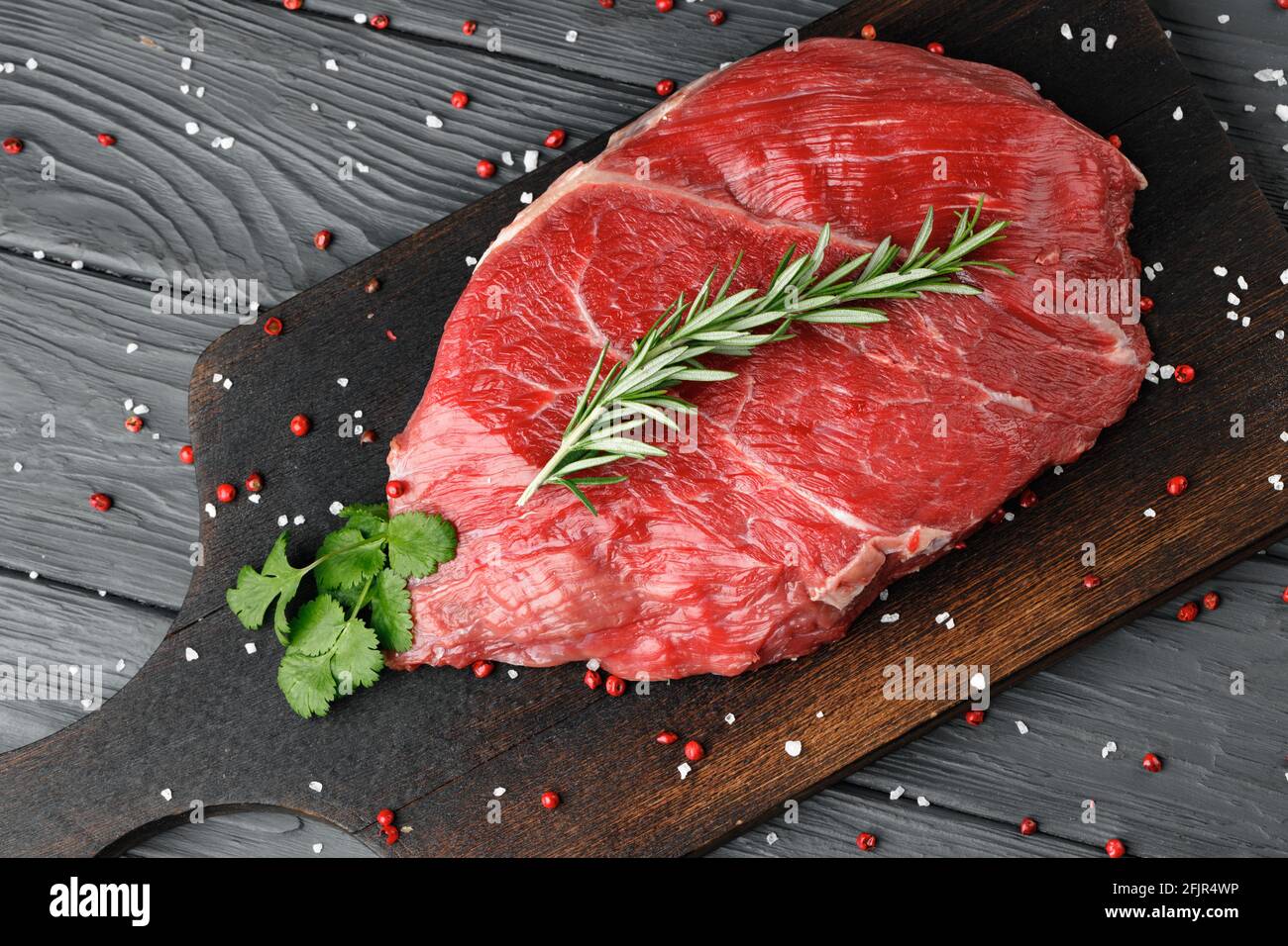 Raw beef fillet piece on wooden board close up Stock Photo - Alamy