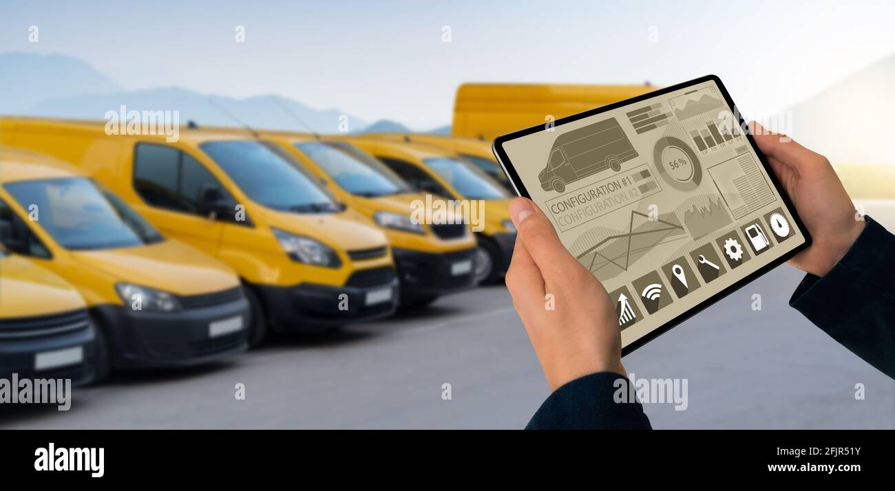 Manager with a digital tablet on the background of vans. Fleet ...