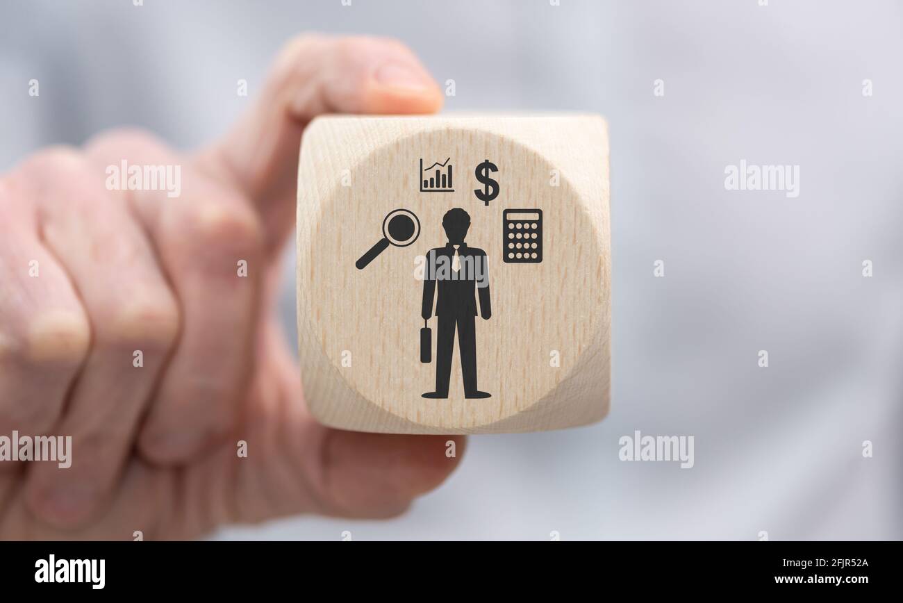 Hand holding a wooden cube with symbol of financial audit concept Stock ...