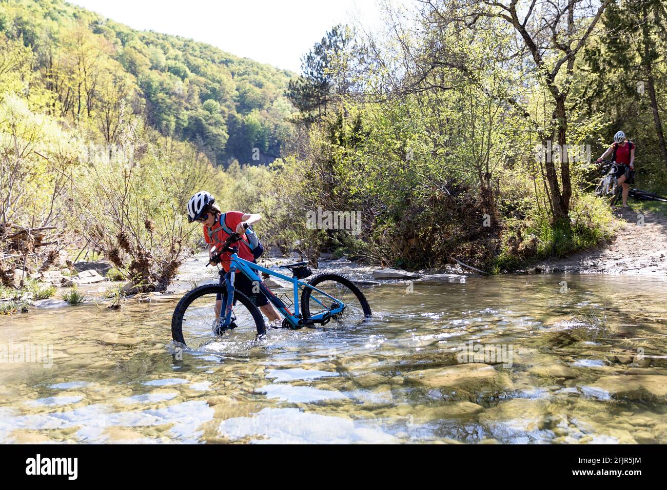 Boy pushing bicycle hi-res stock photography and images - Alamy