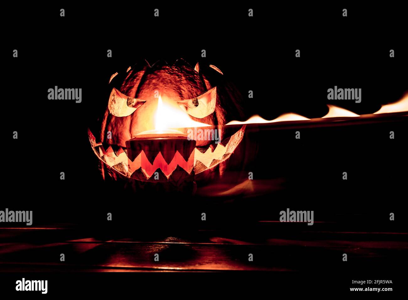 Carved spooky halloween pumpkin with glowing hot fire flame face. Big ...