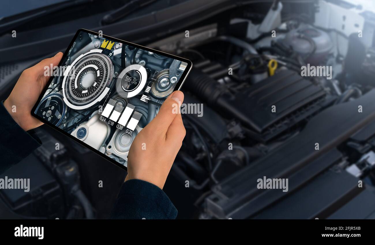 Serviceman repairing a car using augmented reality application Stock ...