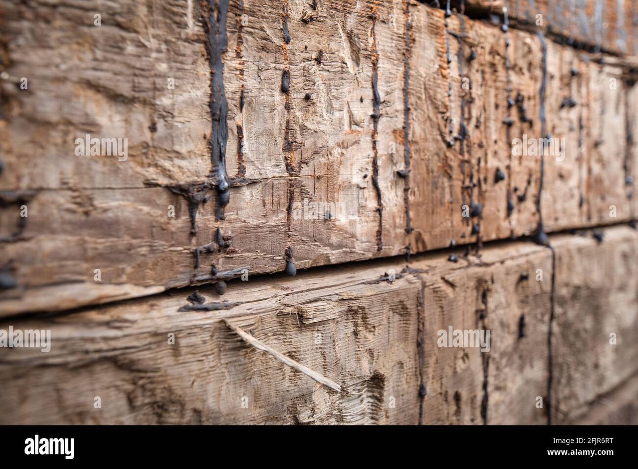 Stack of railway beams, track underlays, old wooden balks, wood tar ...