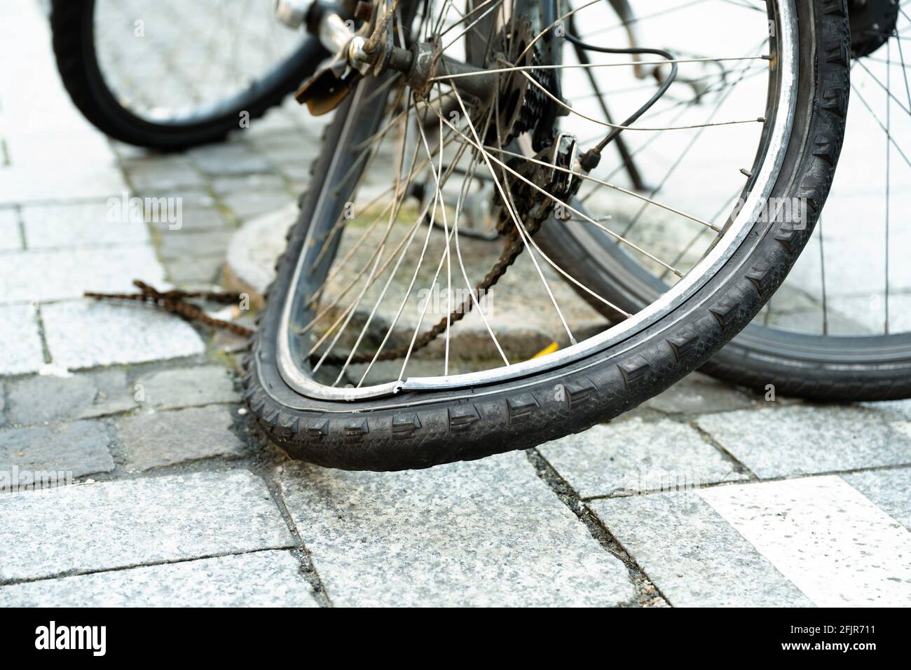 The bent rear tire of a bicycle in the city with destroyed chain Stock ...