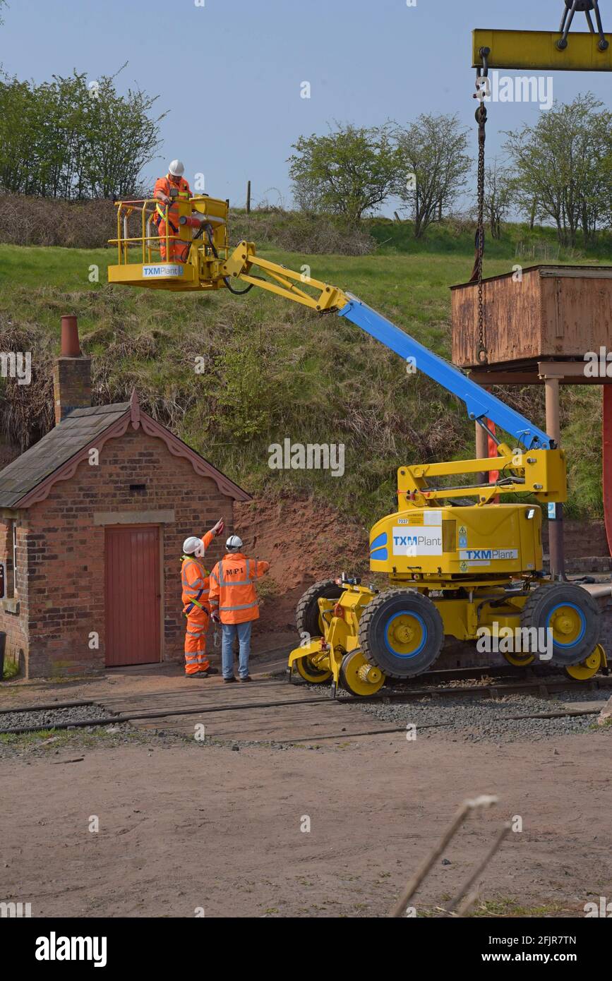 Severn Valley Railway volunteer rail engineers using a rail mounted ...