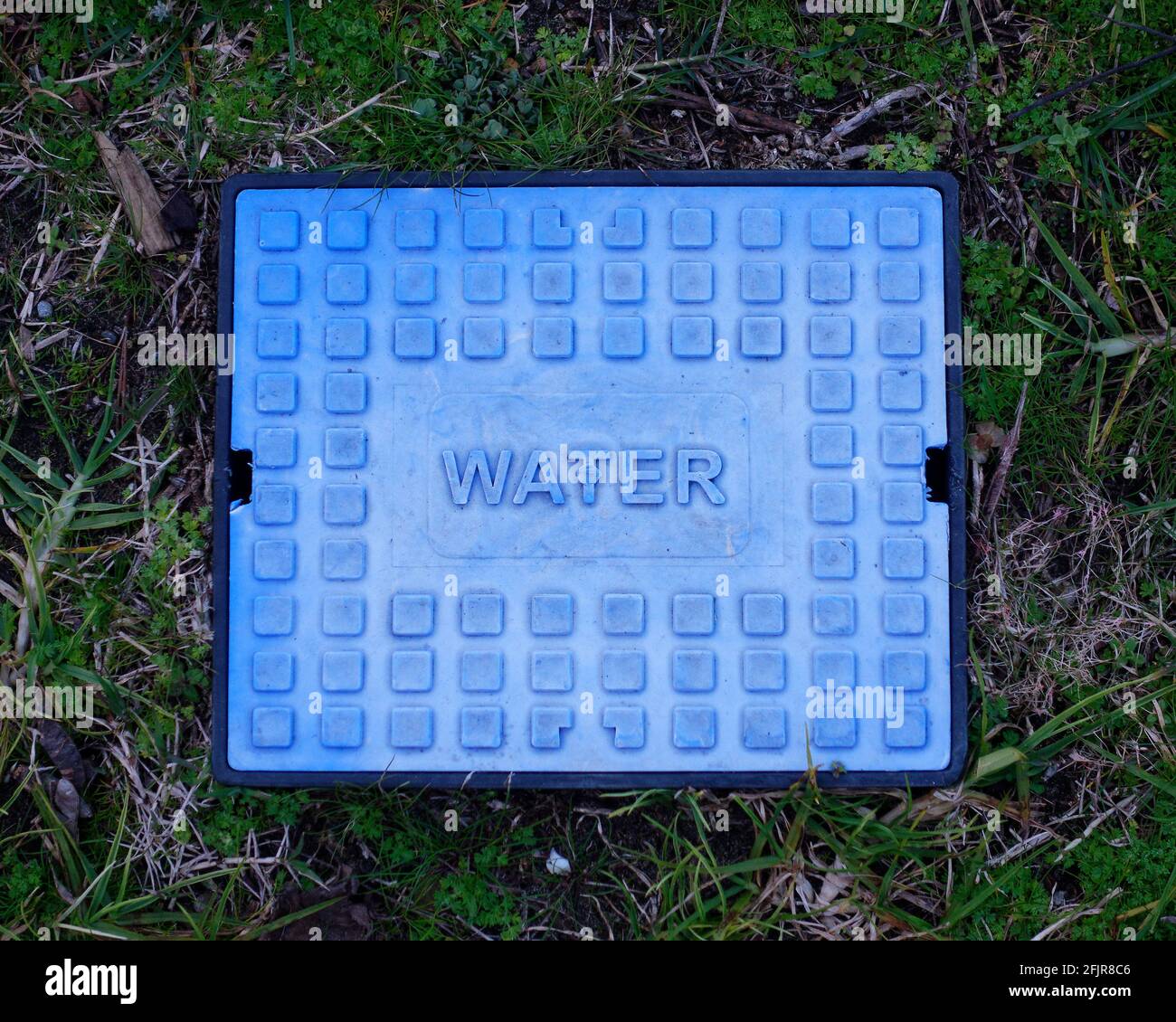 A blue water utility company hatch in a lawn Stock Photo - Alamy