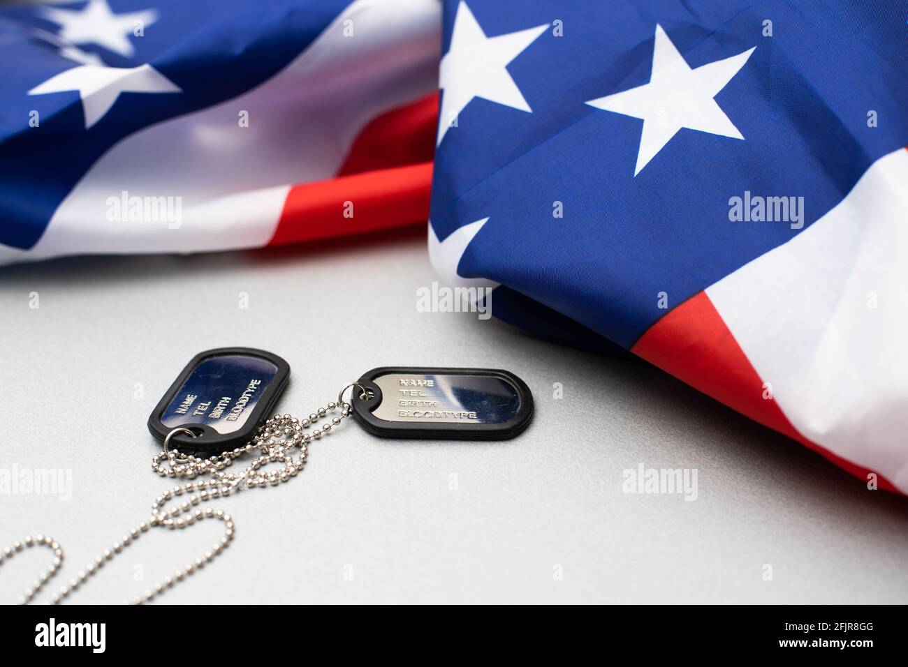 Army tokens on American national flag background Stock Photo - Alamy