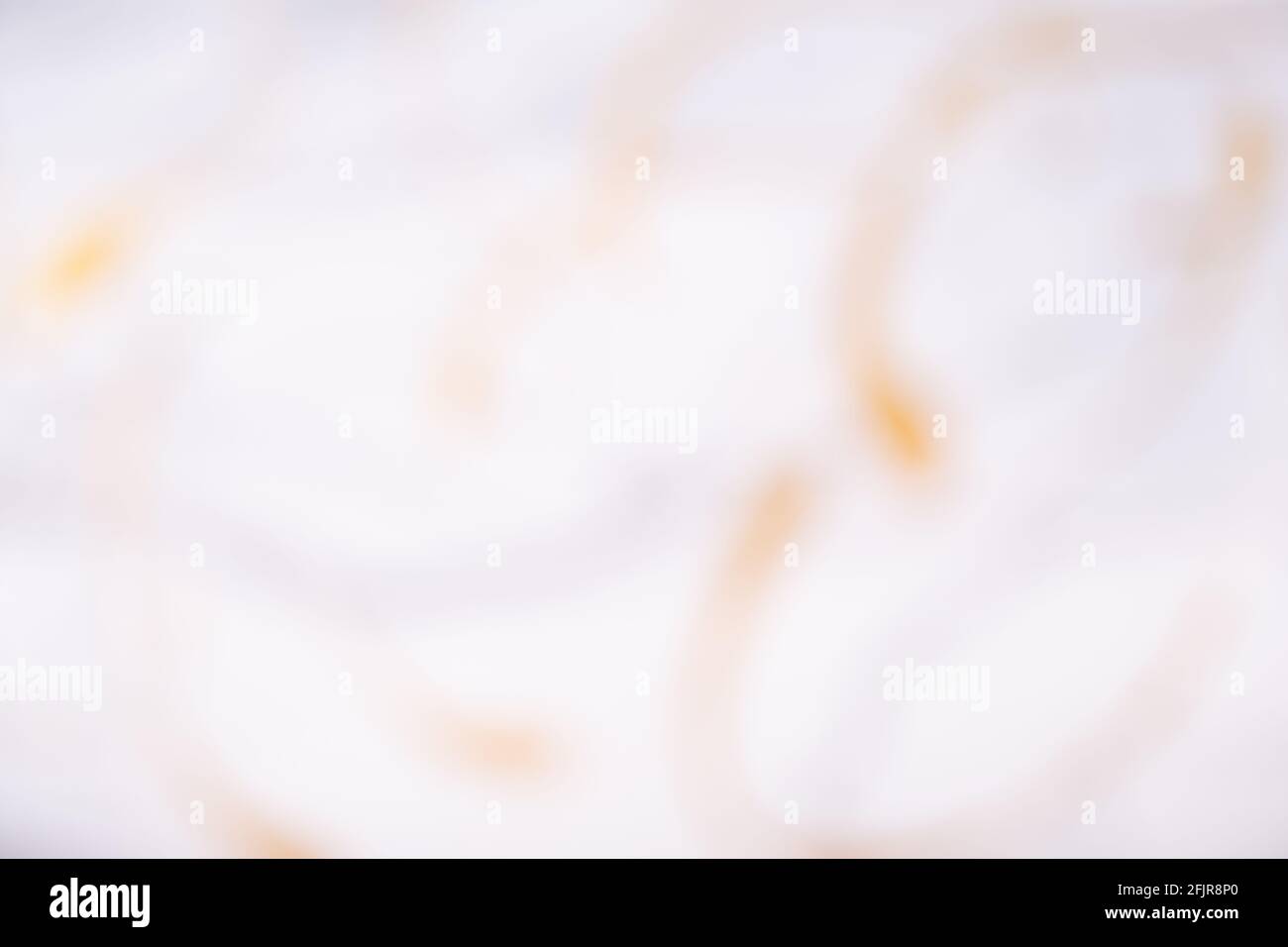Blurred white and golden background with wavy pattern. Defocused art ...