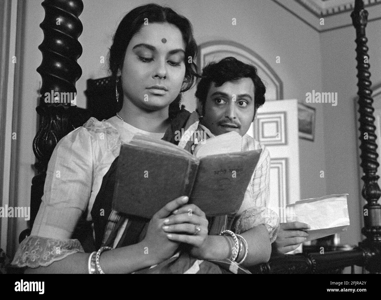SOUMITRA CHATTERJEE and MADHABI MUKHERJEE in CHARULATA (1964), directed by SATYAJIT RAY. Credit ...