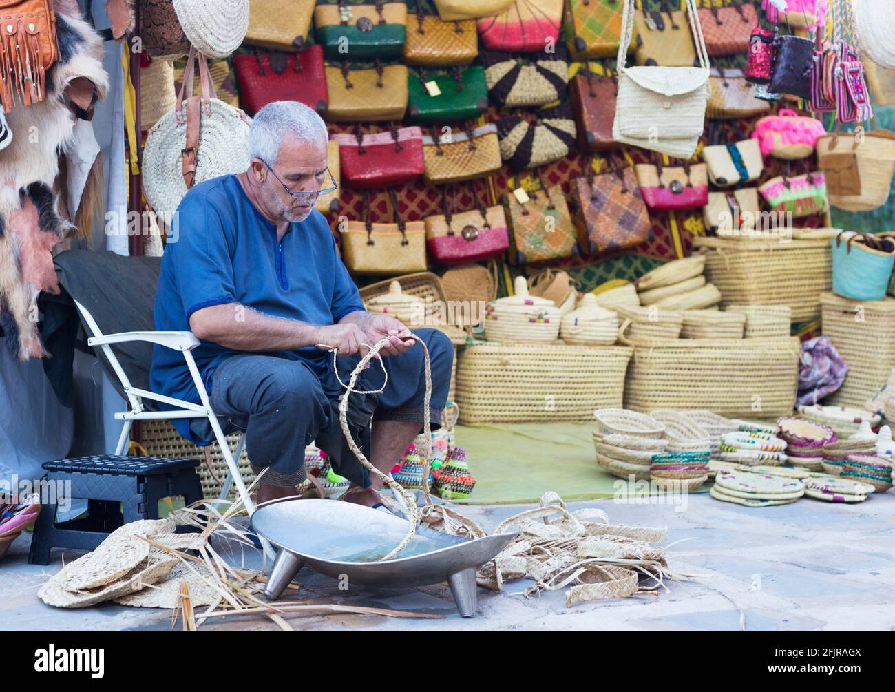 Man weaves baskets in a medieval market fair Stock Photo - Alamy