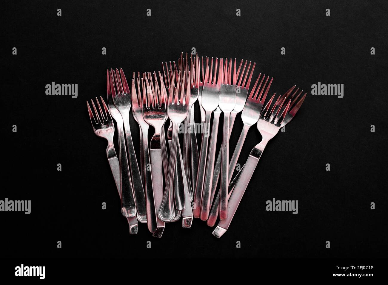 Simple and modern design forks viewed from above on clean black ...