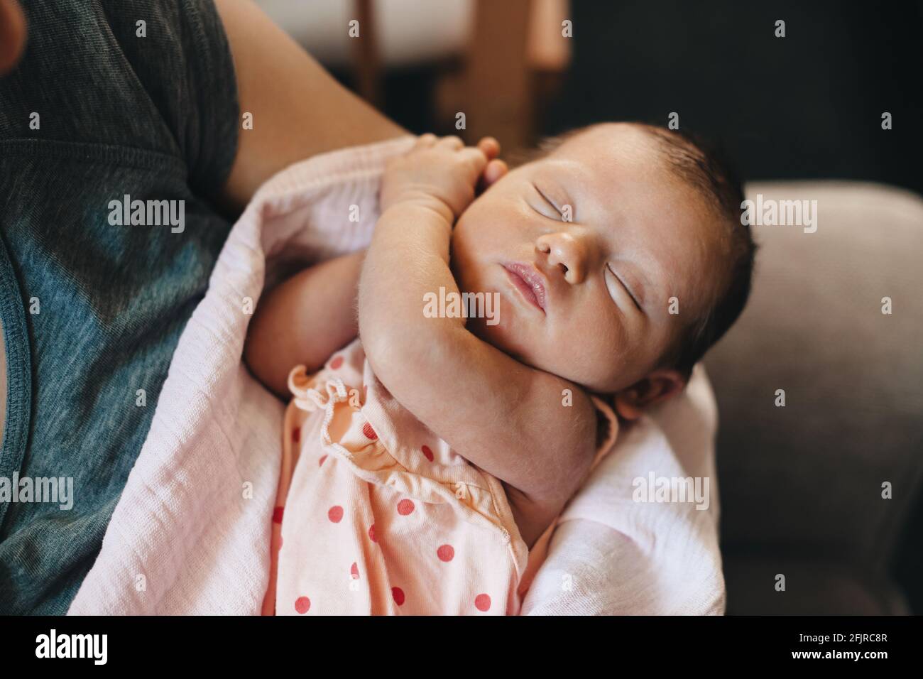Close up photo of a caucasian kid napping while his mother is holding ...