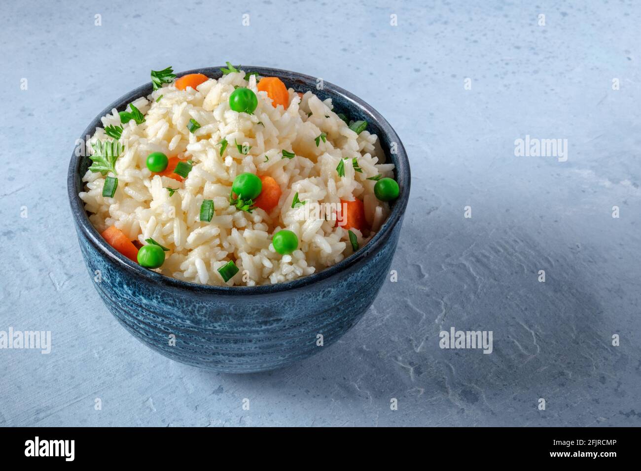 Vegetable rice in a blue bowl Stock Photo - Alamy