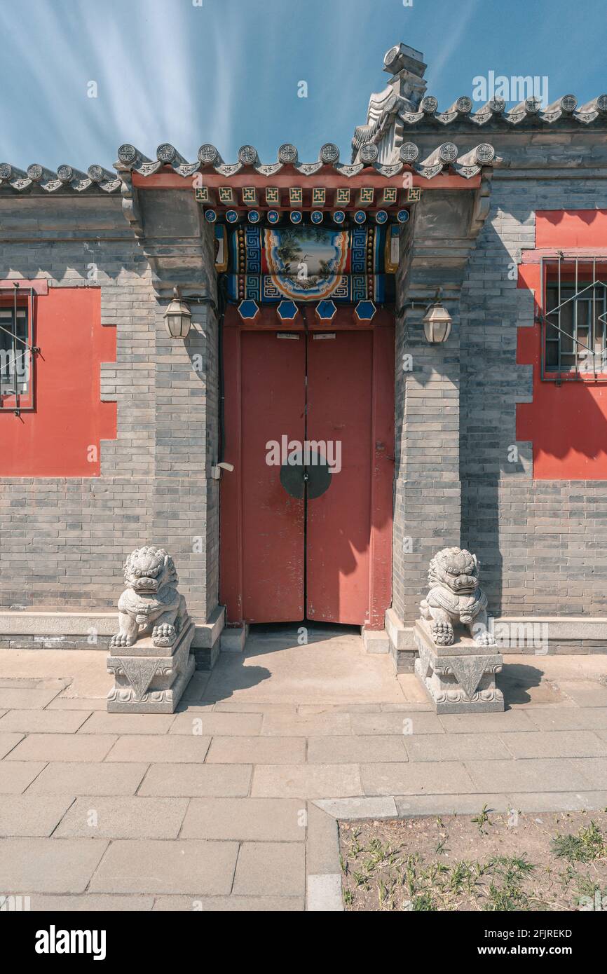 Ancient buildings with gray brick wall and Chinese lion stone in the ...