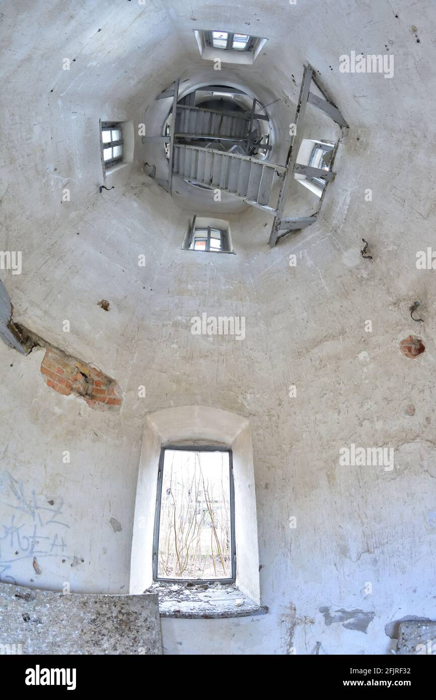 The interior of an abandoned and neglected tower with windows and ...