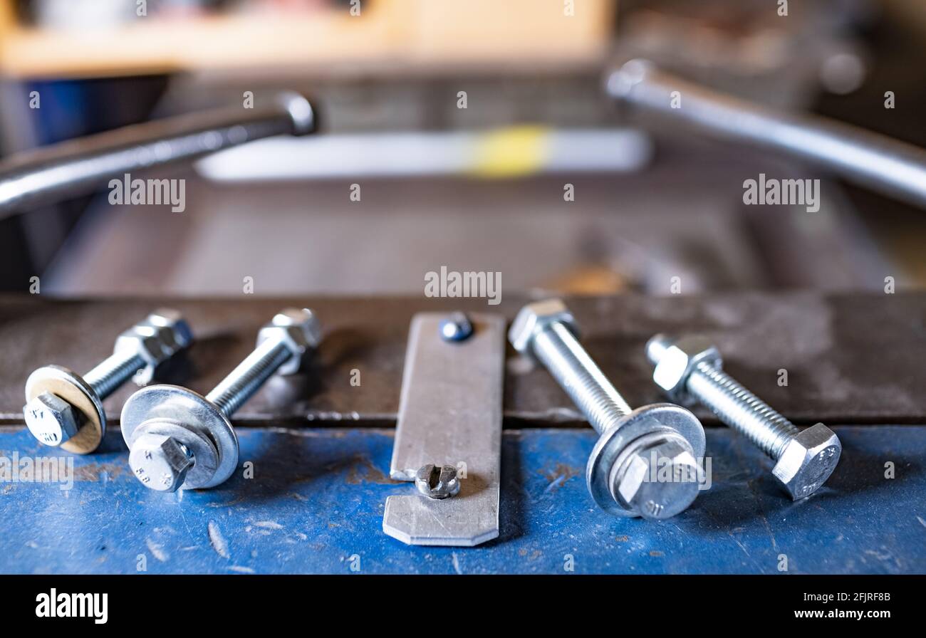 Metal chrome bolts and nuts on manual flexible massive machine. Old ...