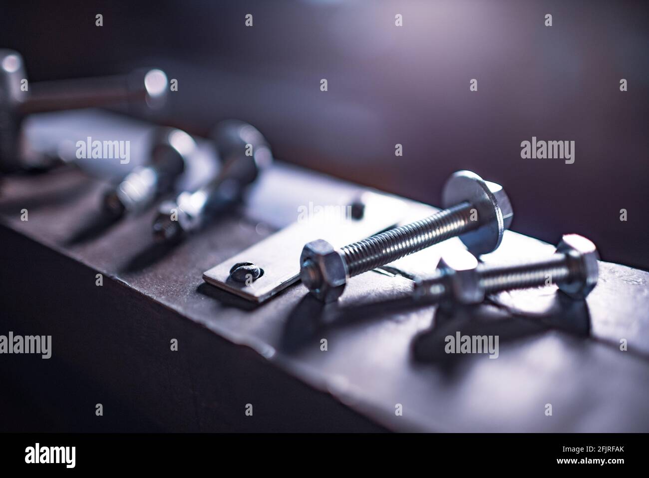 Metal chrome bolts and nuts on manual flexible massive machine. Old ...