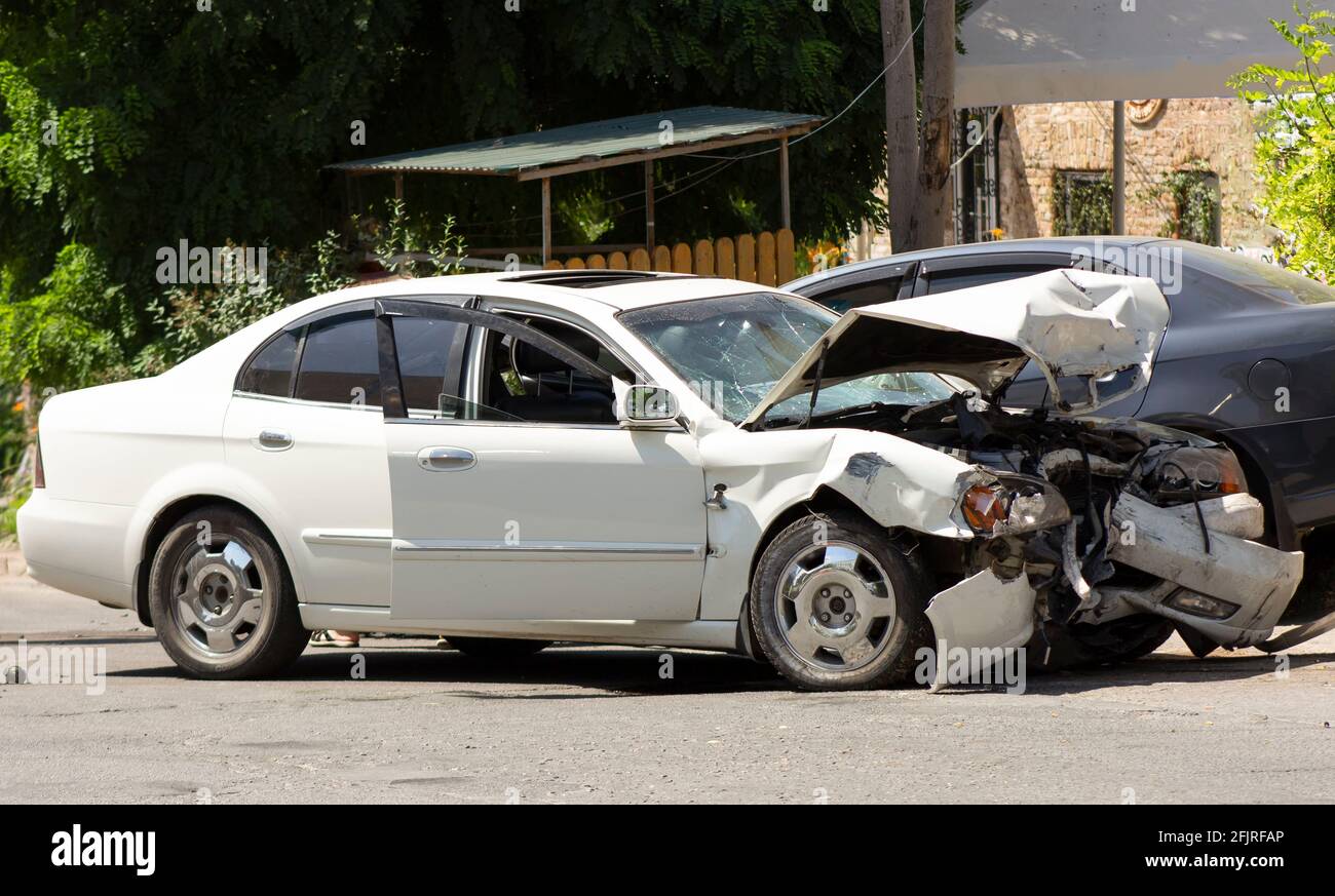 Road accident. Collision of cars at high speed. Wrecked white car Stock ...