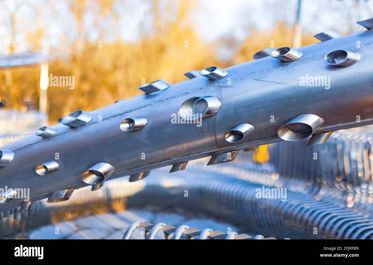 Close-up street bench metal pipes arranged parallel to each other on a ...