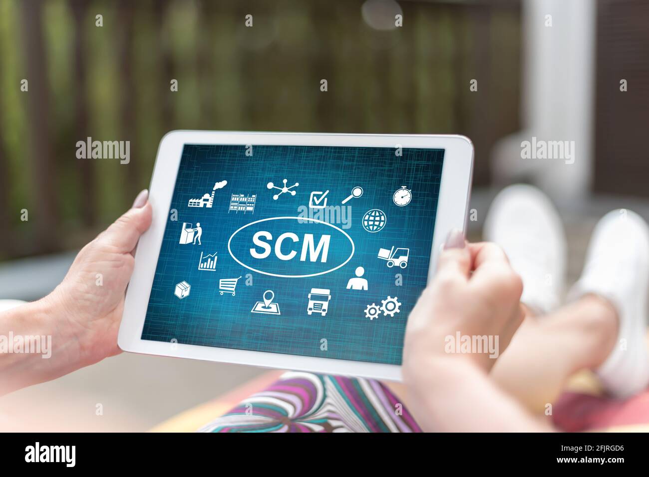 Female hands holding a tablet with scm concept Stock Photo - Alamy