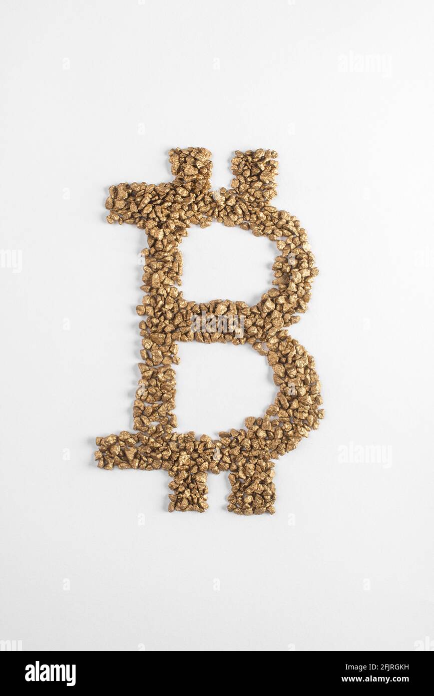 Top view on bitcoin sign made from pieces of gold on white background ...