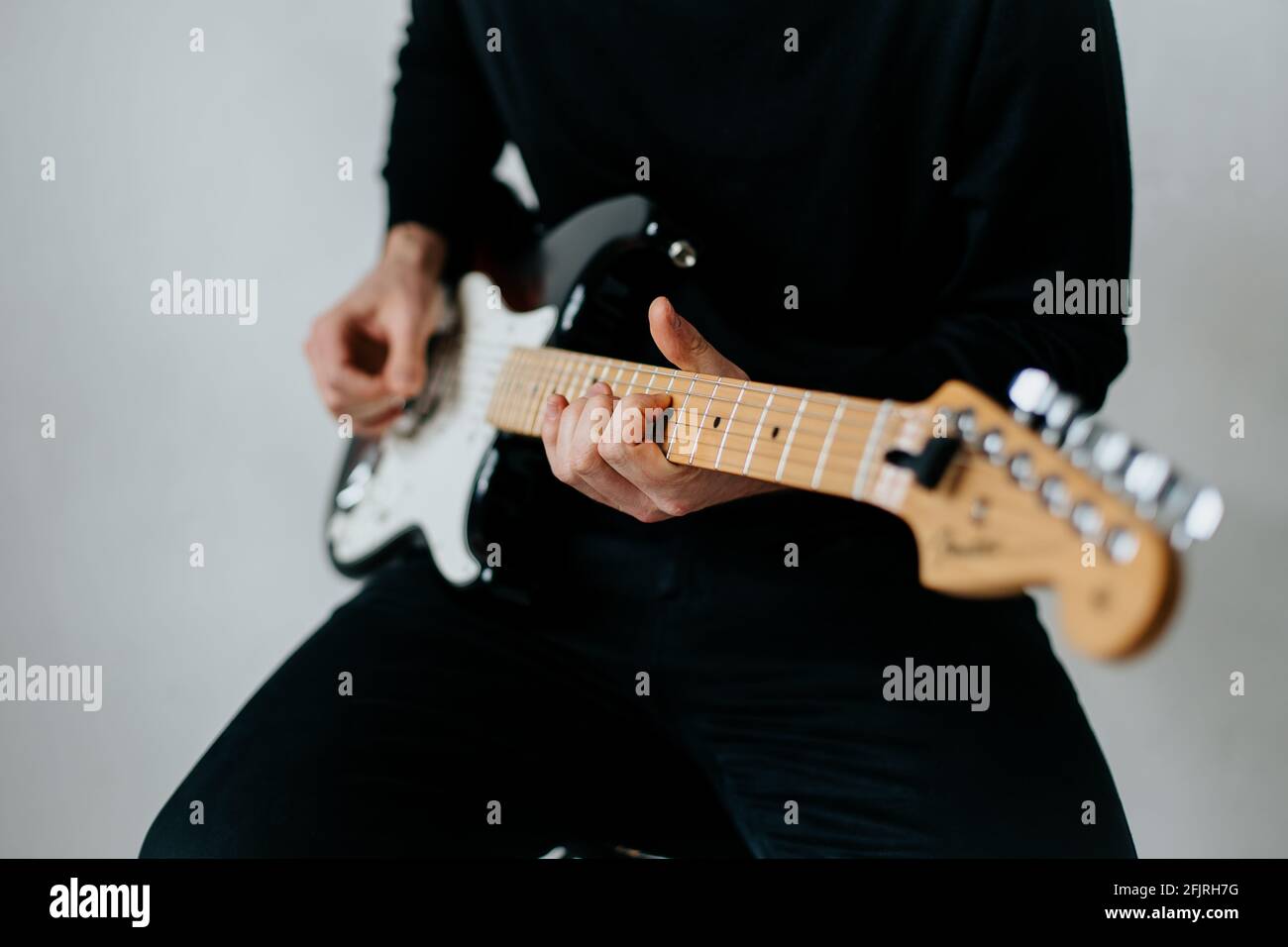 man playing an electric guitar on stage Stock Photo - Alamy