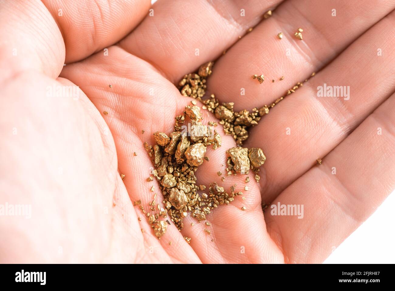 Close-up on small amount of pieces of gold in men's hand Stock Photo ...