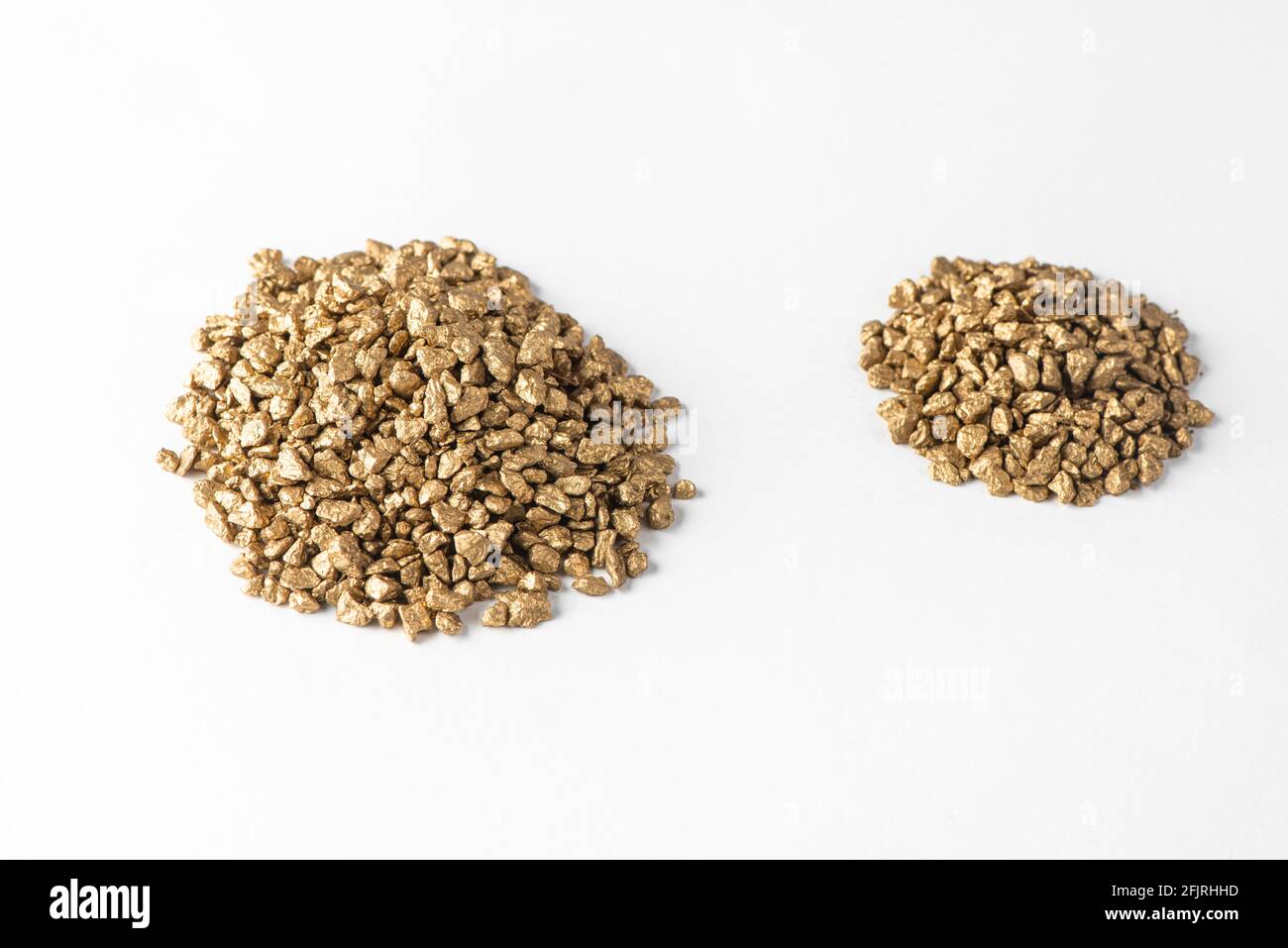 Top view on two heaps of golden nuggets on white background Stock Photo ...