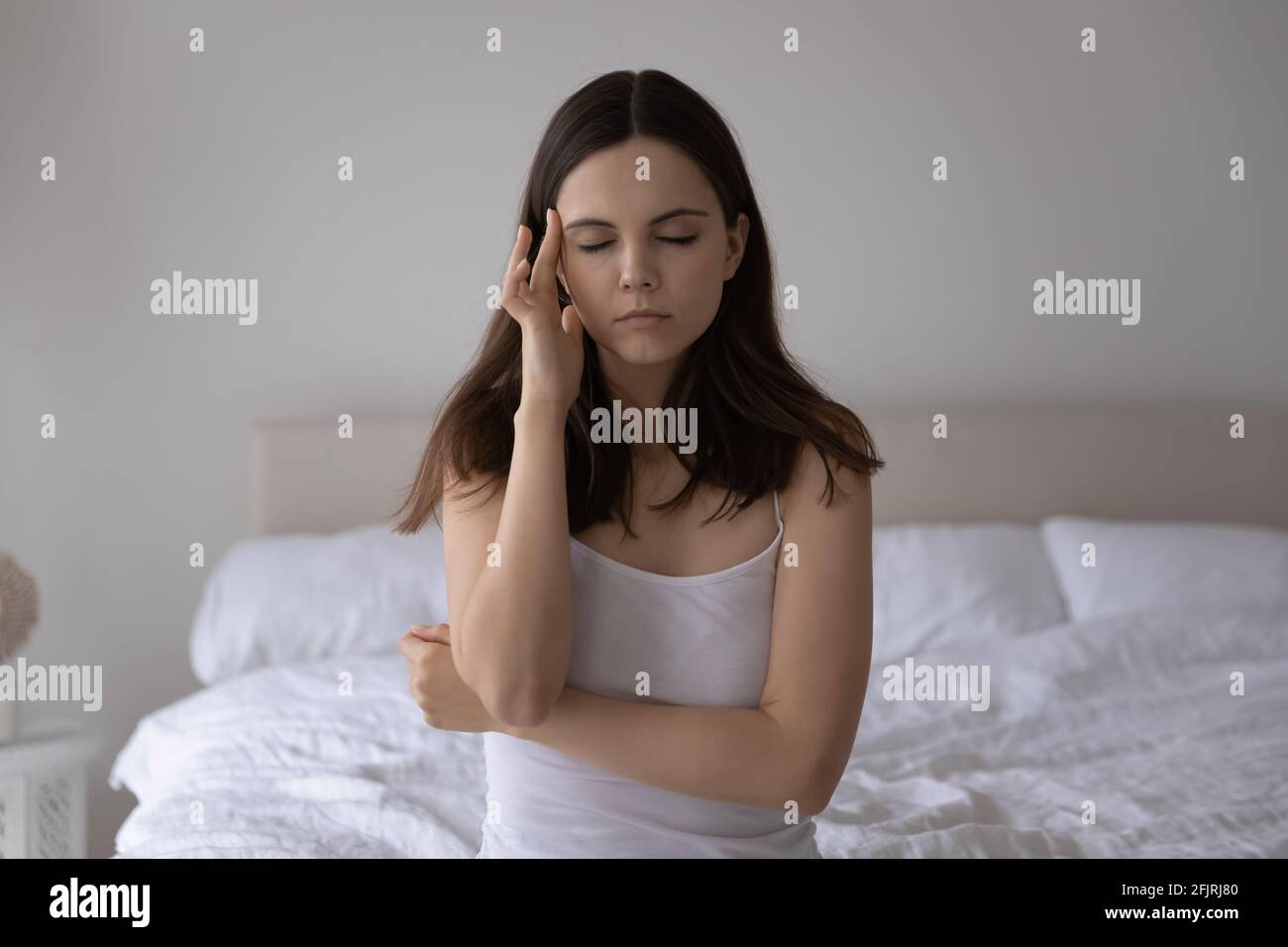 Unhappy stressed millennial girl suffering from morning headache Stock ...