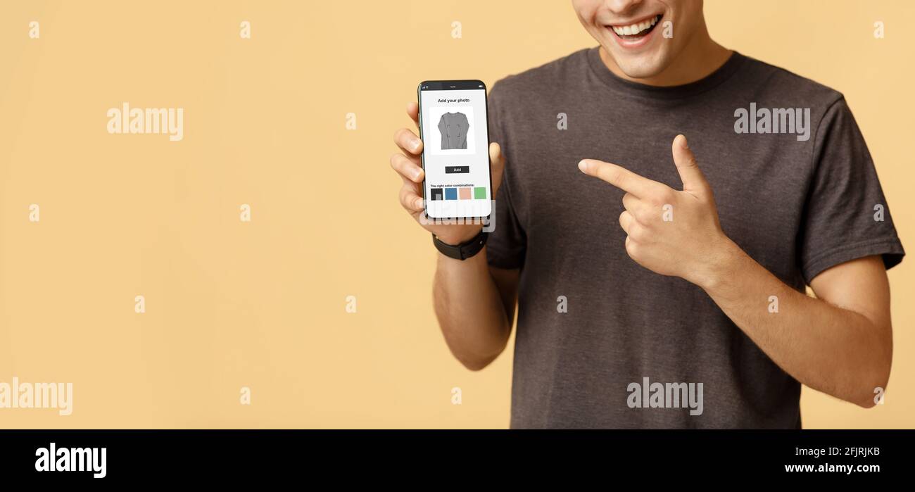 Augmented Reality. Man holding smart phone with clothes shop website ...