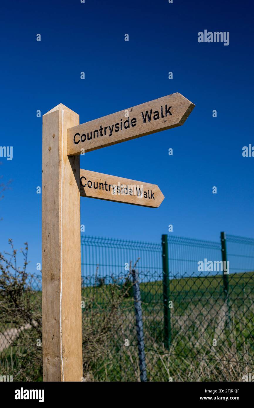 A signpost depicting countryside walks on a bright spring day in ...