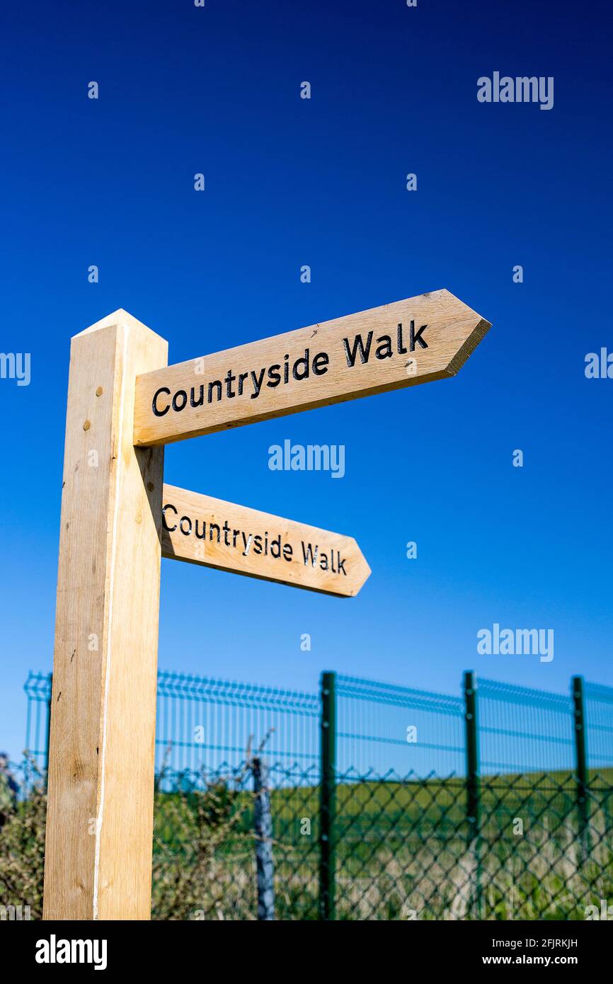 A signpost depicting countryside walks on a bright spring day in ...