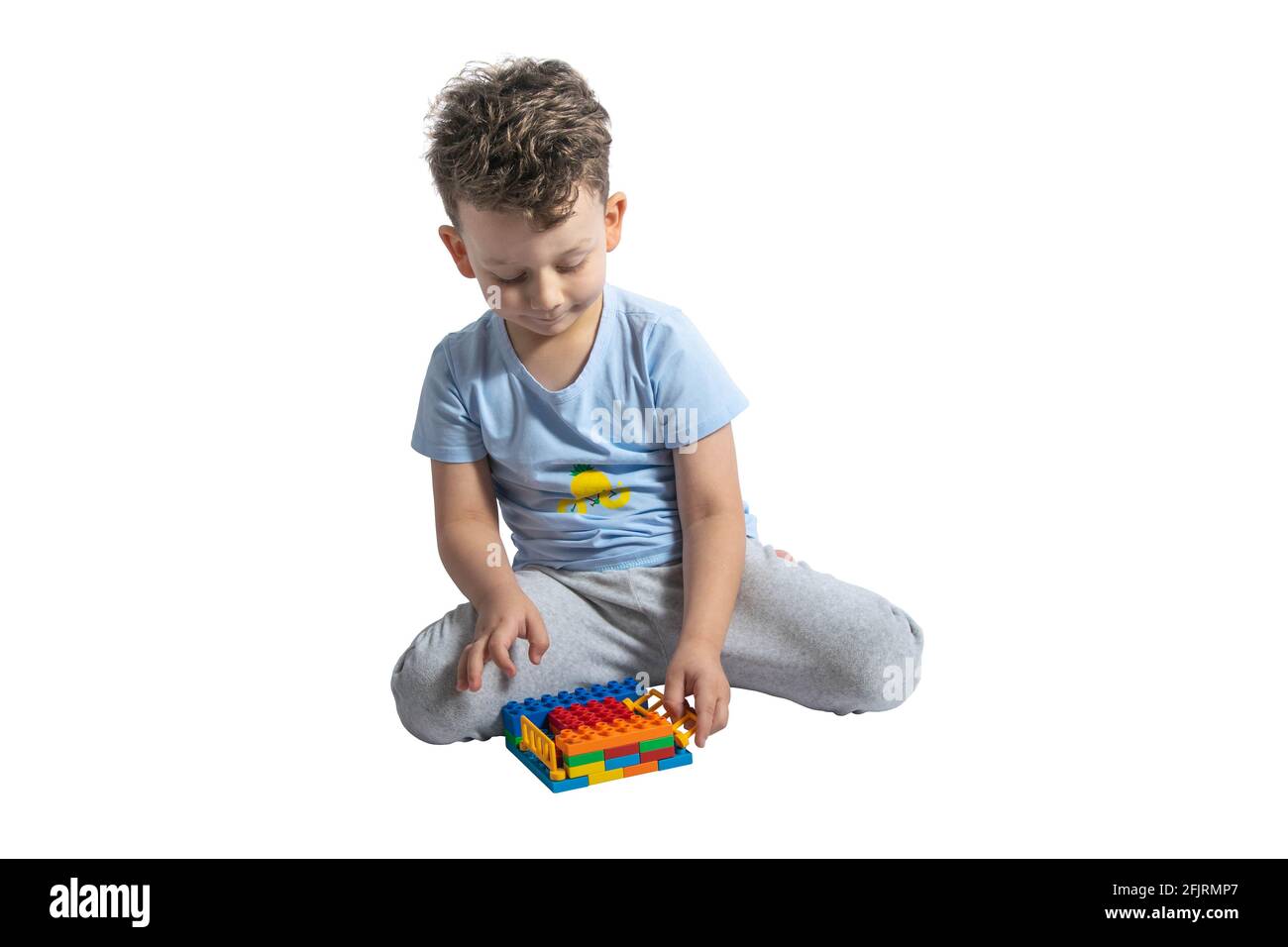 Kid boy playing toy blocks. Isolated on white background Stock Photo ...