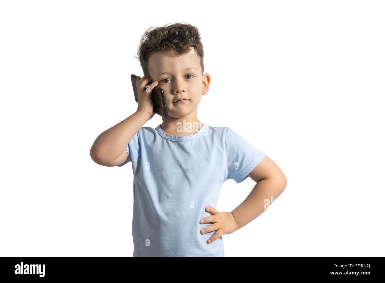 A portrait of a handsome boy talking on the mobile phone isolated on ...