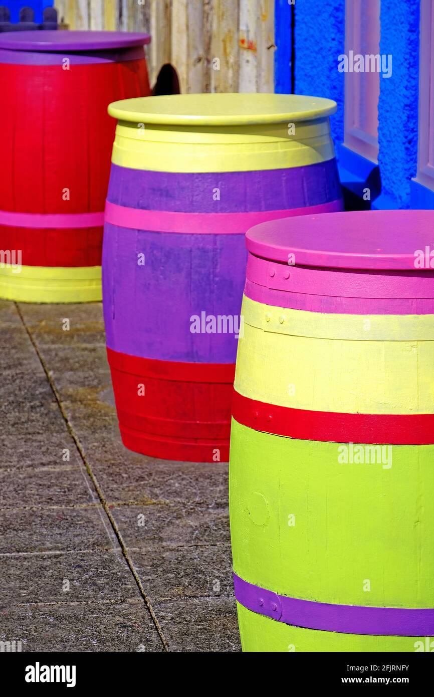3 red blue yellow gaudily painted wooden beer kegs Stock Photo - Alamy