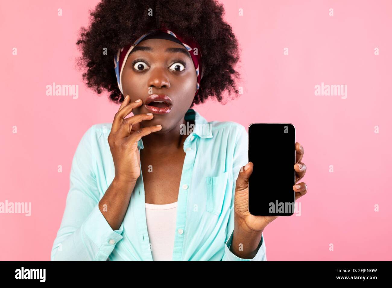Shocked Black Woman Showing Smartphone Blank Screen Over Pink ...