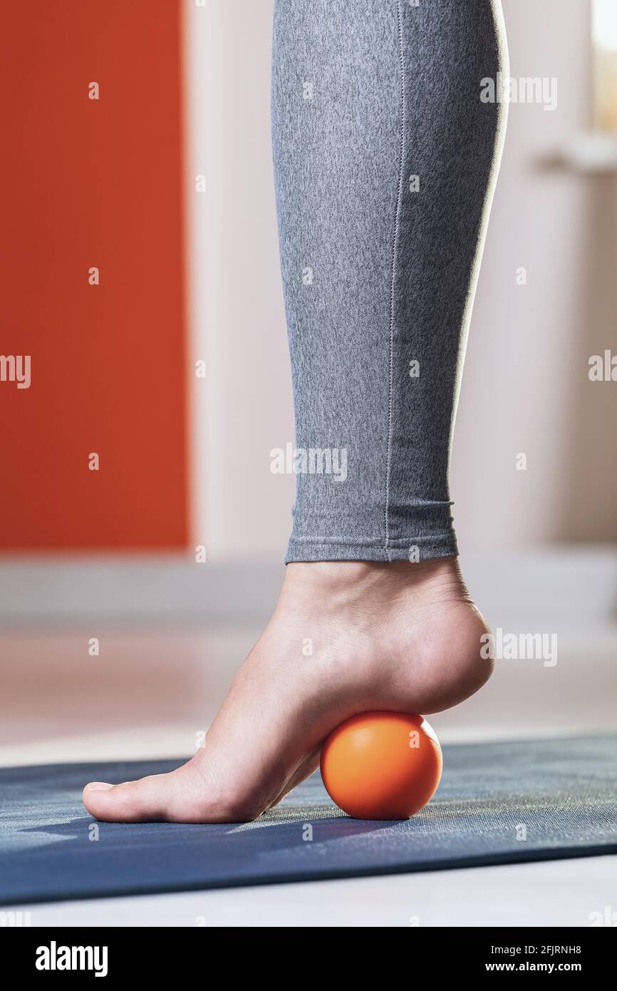 Myofascial relaxation of the muscles of the foot with a massage ball on ...