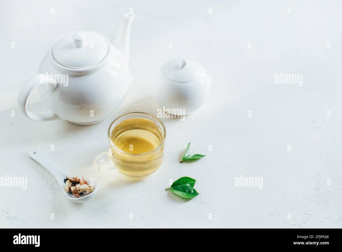 tea service with tea in a transparent cup on a white background with ...
