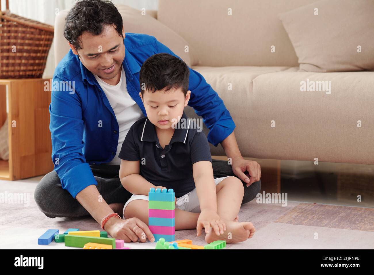 Child smiling building blocks tower hi-res stock photography and images ...