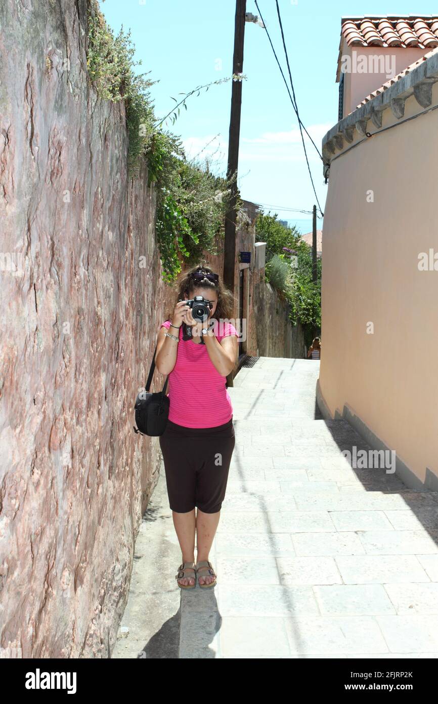 Teenage girl, tourist, takes pictures of the photographer who ...