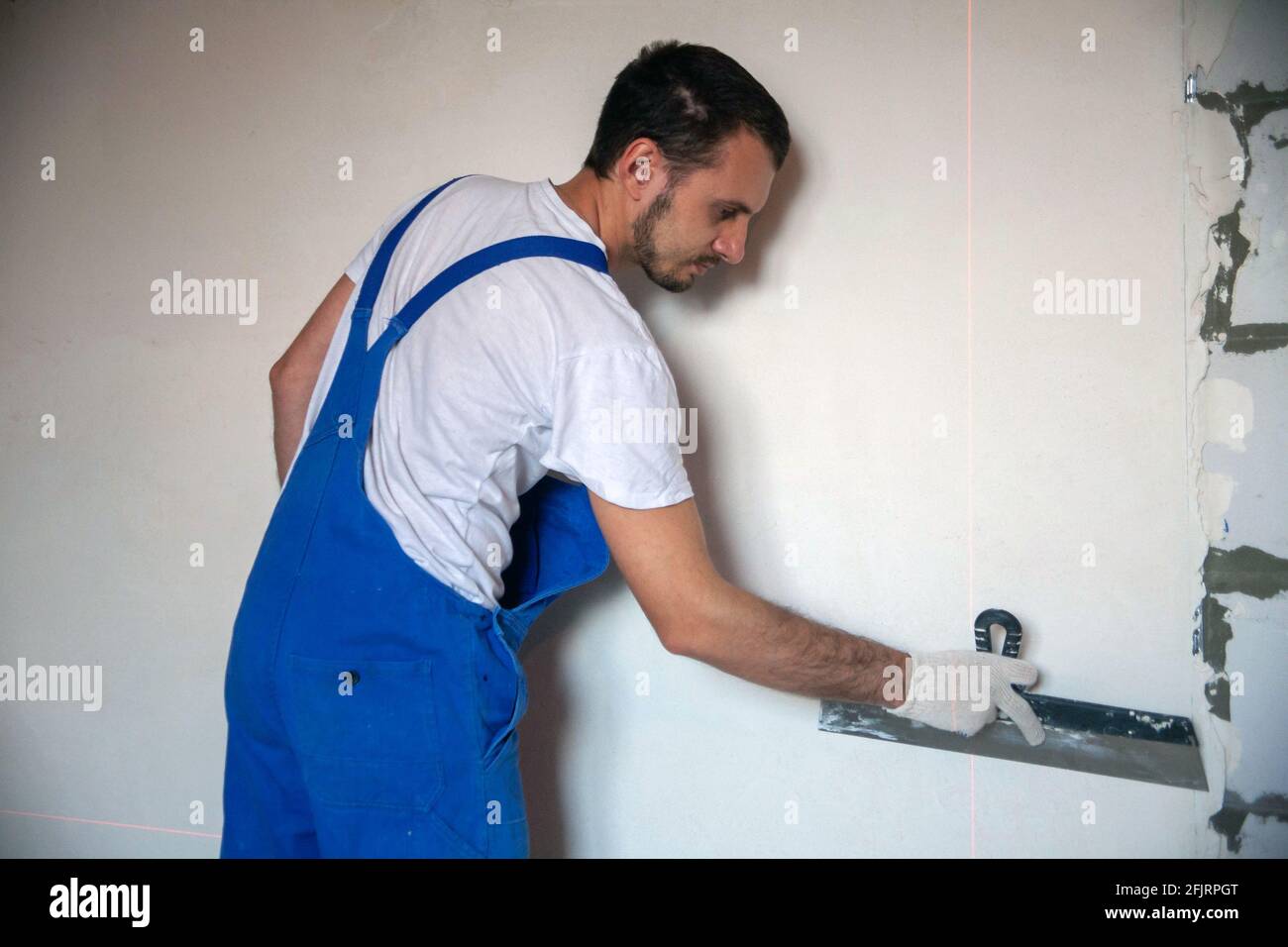 work on finishing the walls with mixtures of plaster and putty when ...