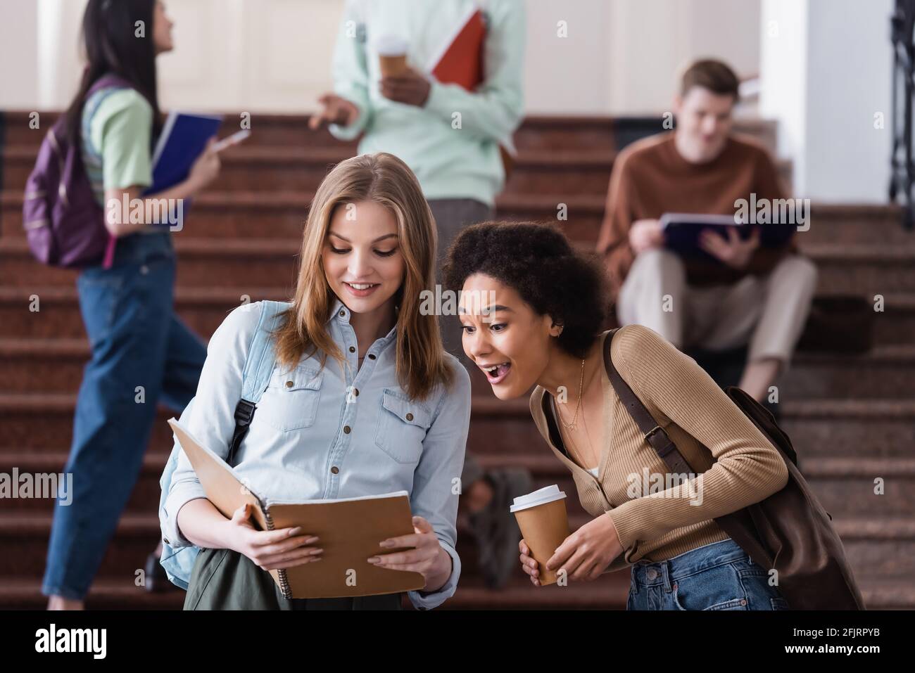 Smiling students standing notebook hi-res stock photography and images ...