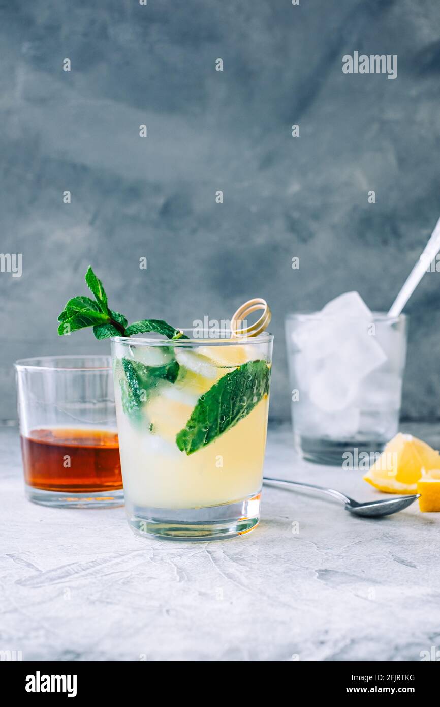 Ice lemonade in glass with lemon pieces, fresh mint and ice cubes Stock ...