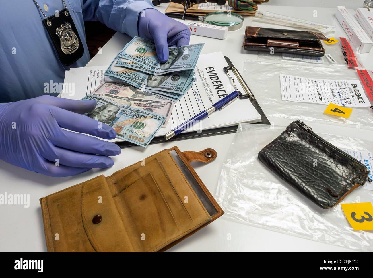 Specialised police officer notes dollar banknote reference of a robbery ...