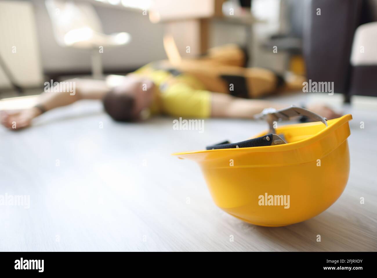 Yellow safety helmet is lying on floor near dead worker concept Stock ...