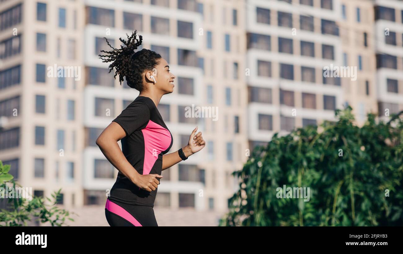 Running in urban park, athlete woman jogging outside, workout alone at ...