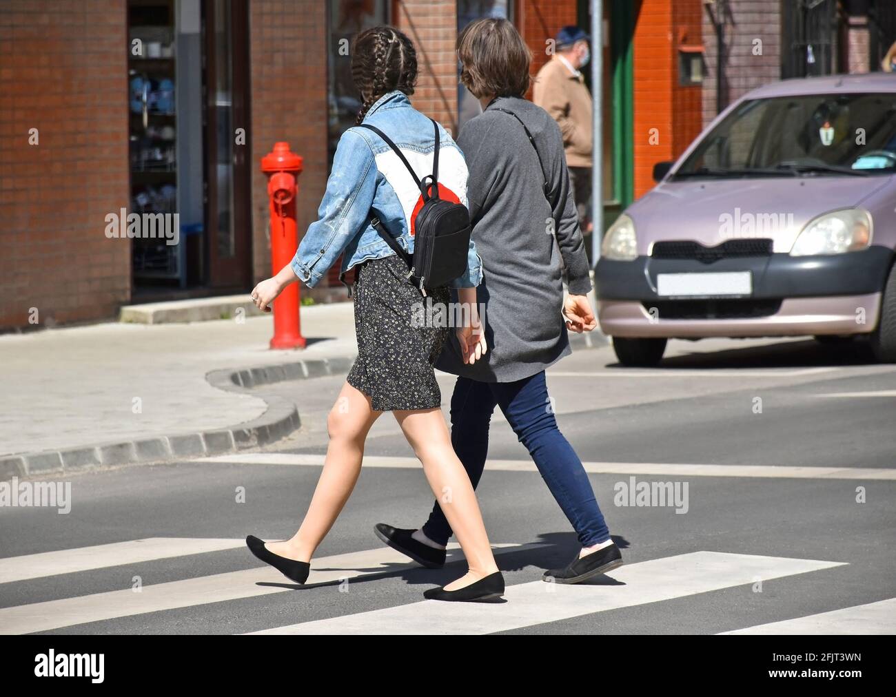 Women are walking at the pedestrian crossing Stock Photo - Alamy