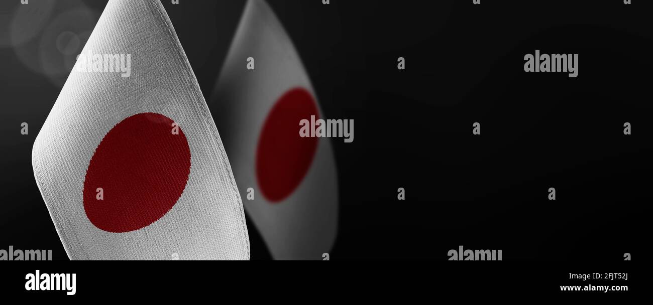 Small national flags of the Japan on a dark background Stock Photo - Alamy